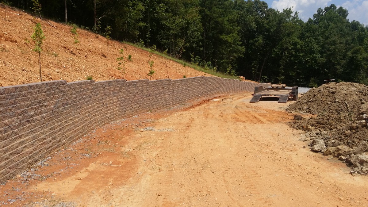 Retaining Wall Installed To Stabilize Hillside Above Driveway
